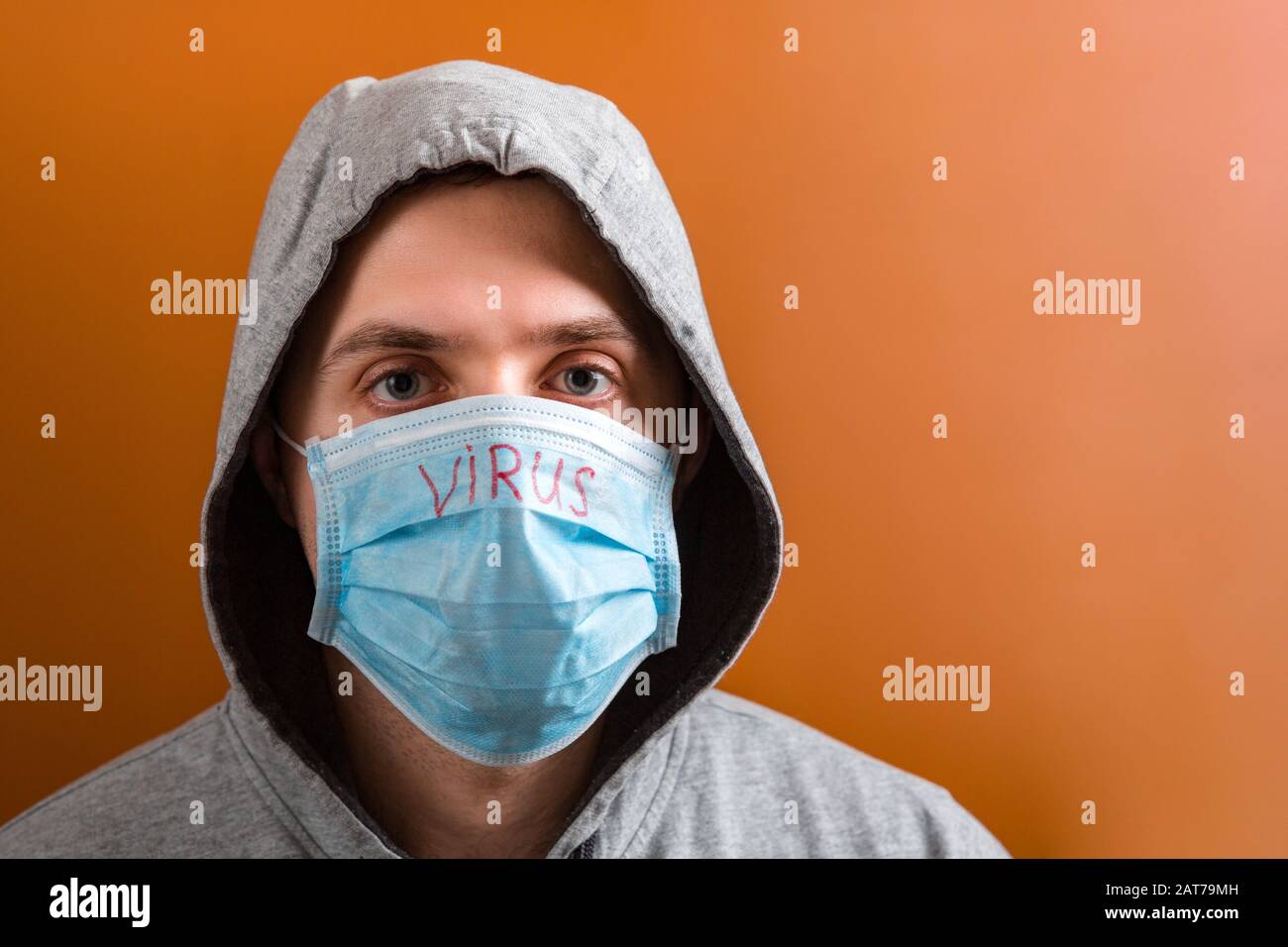 Portrait of a man in hood on his head wearing medical mask with virus ...
