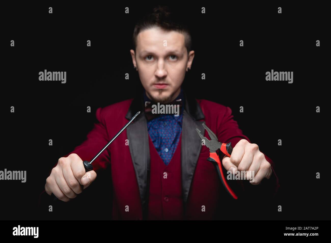 Male magician is experimenting with magic wands using screwdriver tool ...