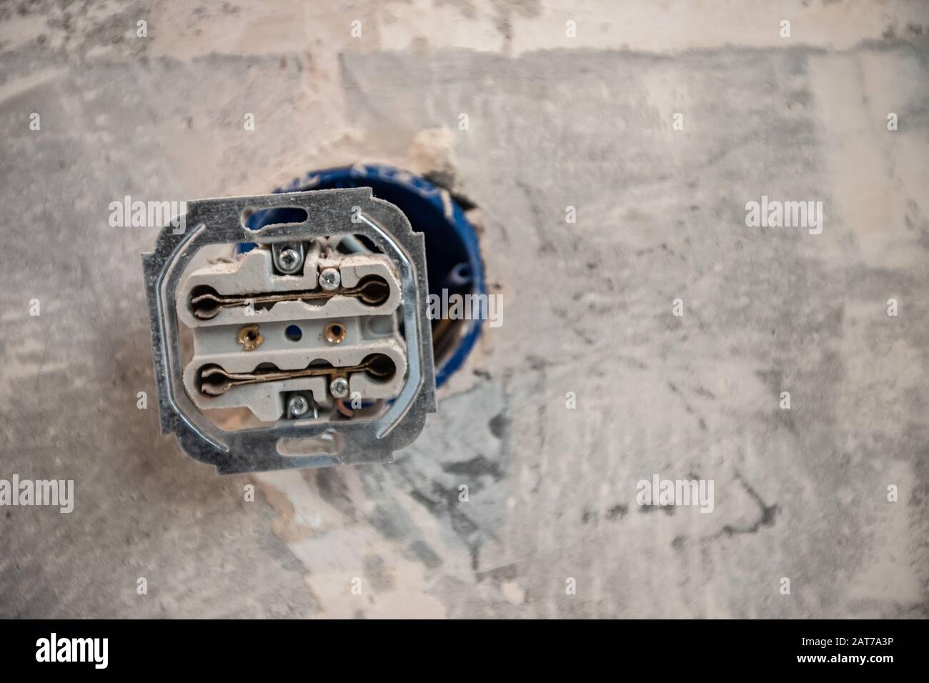 Disassembled electrical outlet in detonation wall with bare wires and ...