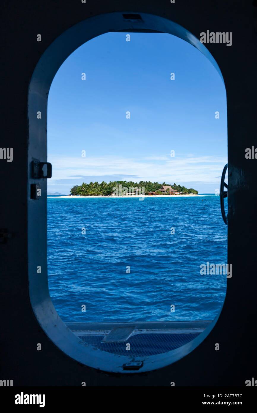 Fijian tropical island view from a boat door porthole, Fiji, Pacific ...