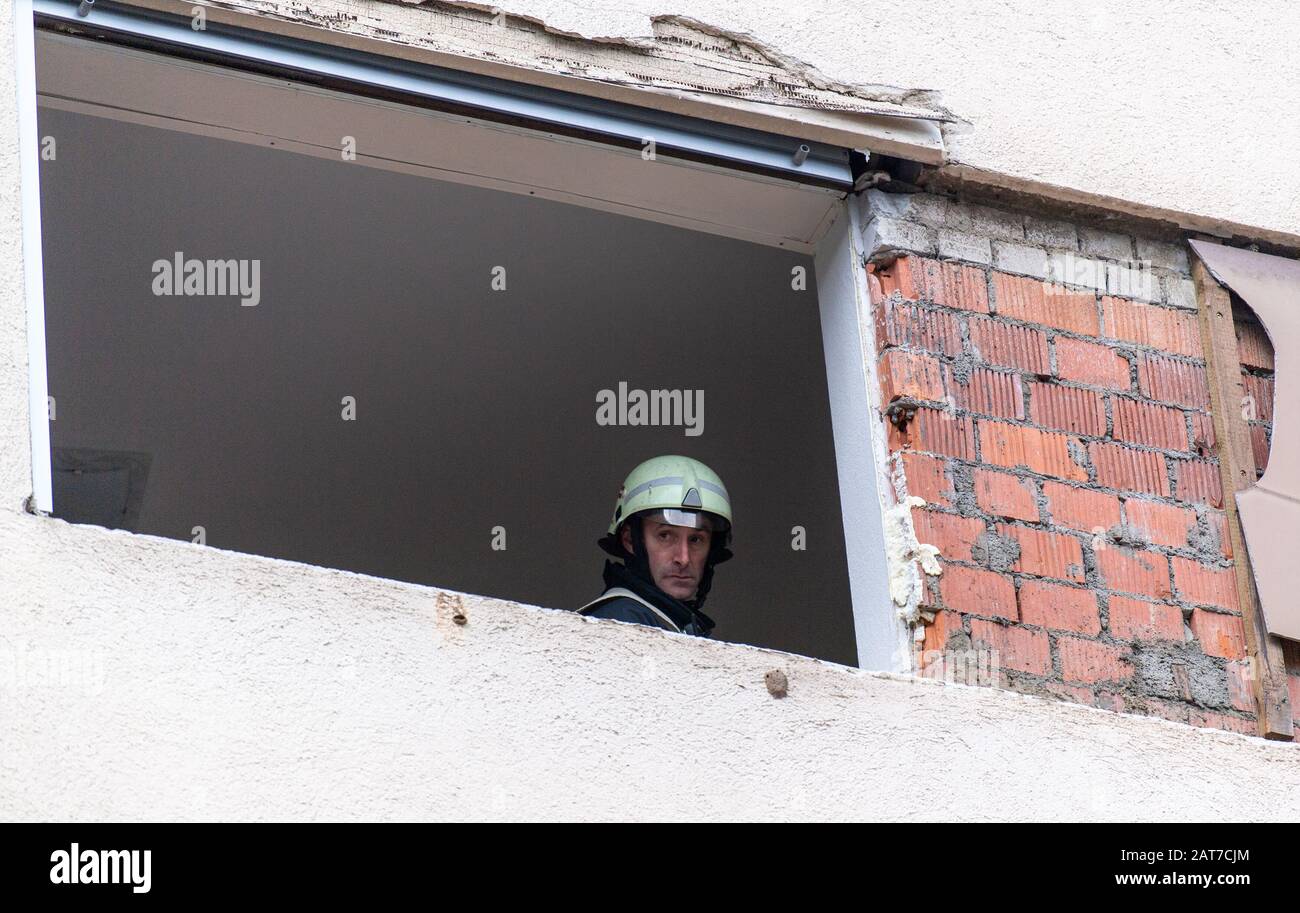 Freiburg, Germany. 31st Jan, 2020. A firefighter looks out a damaged ...