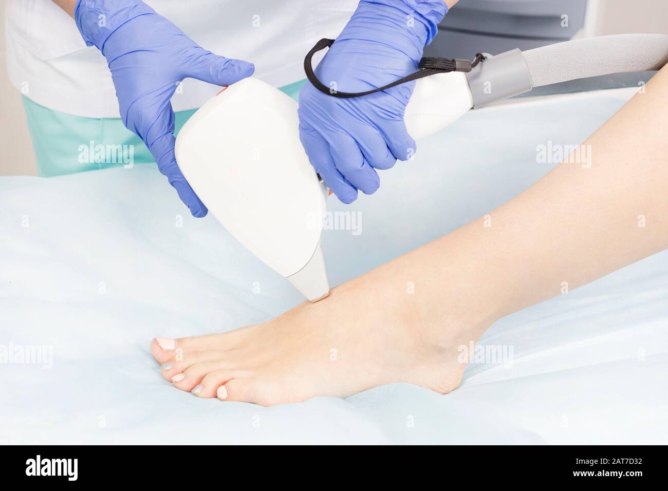 The process of laser depilation of female limbs in the beauty salon ...