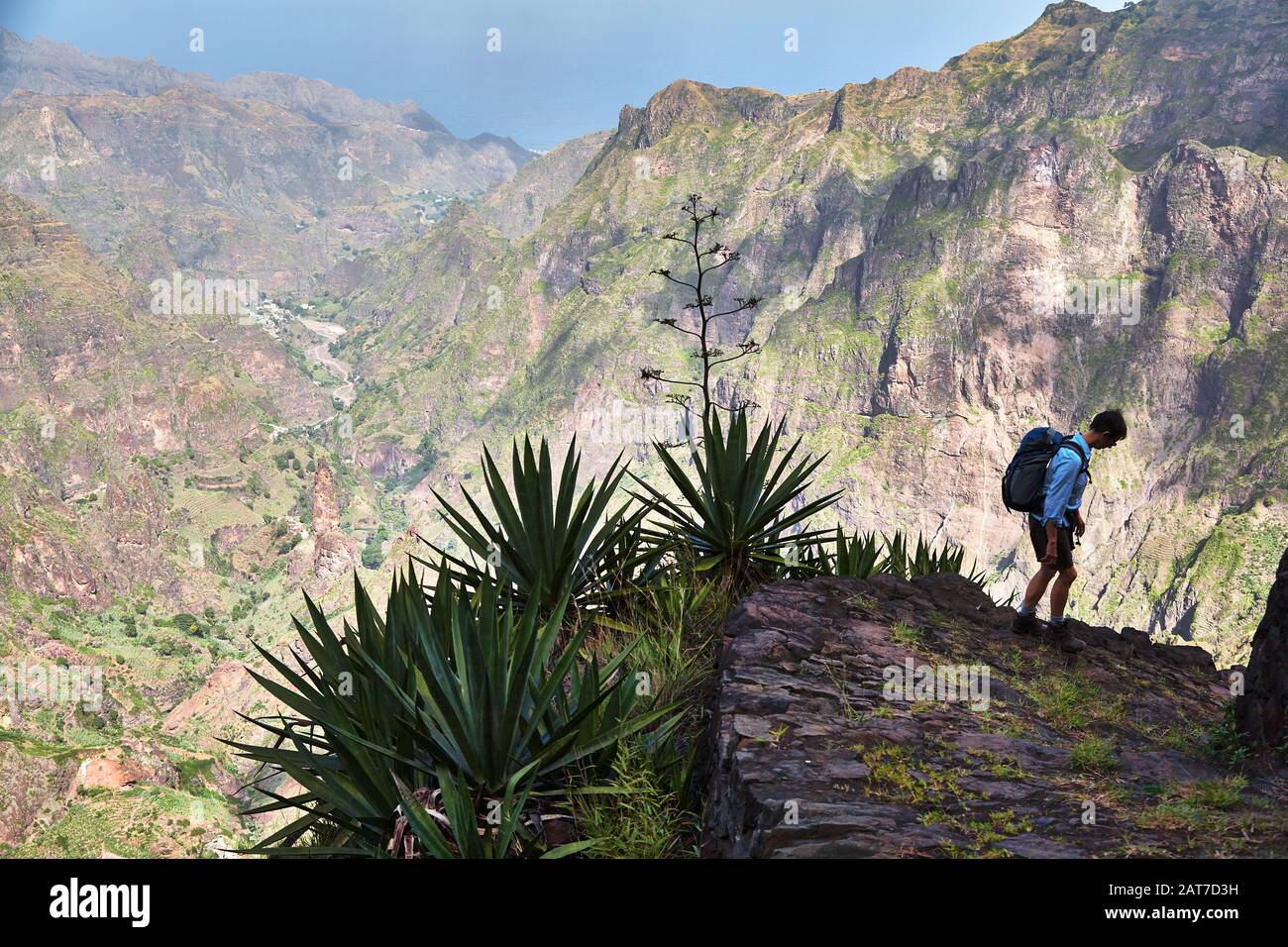 A female walker descending the steep path into the ravine of Ribiera de ...