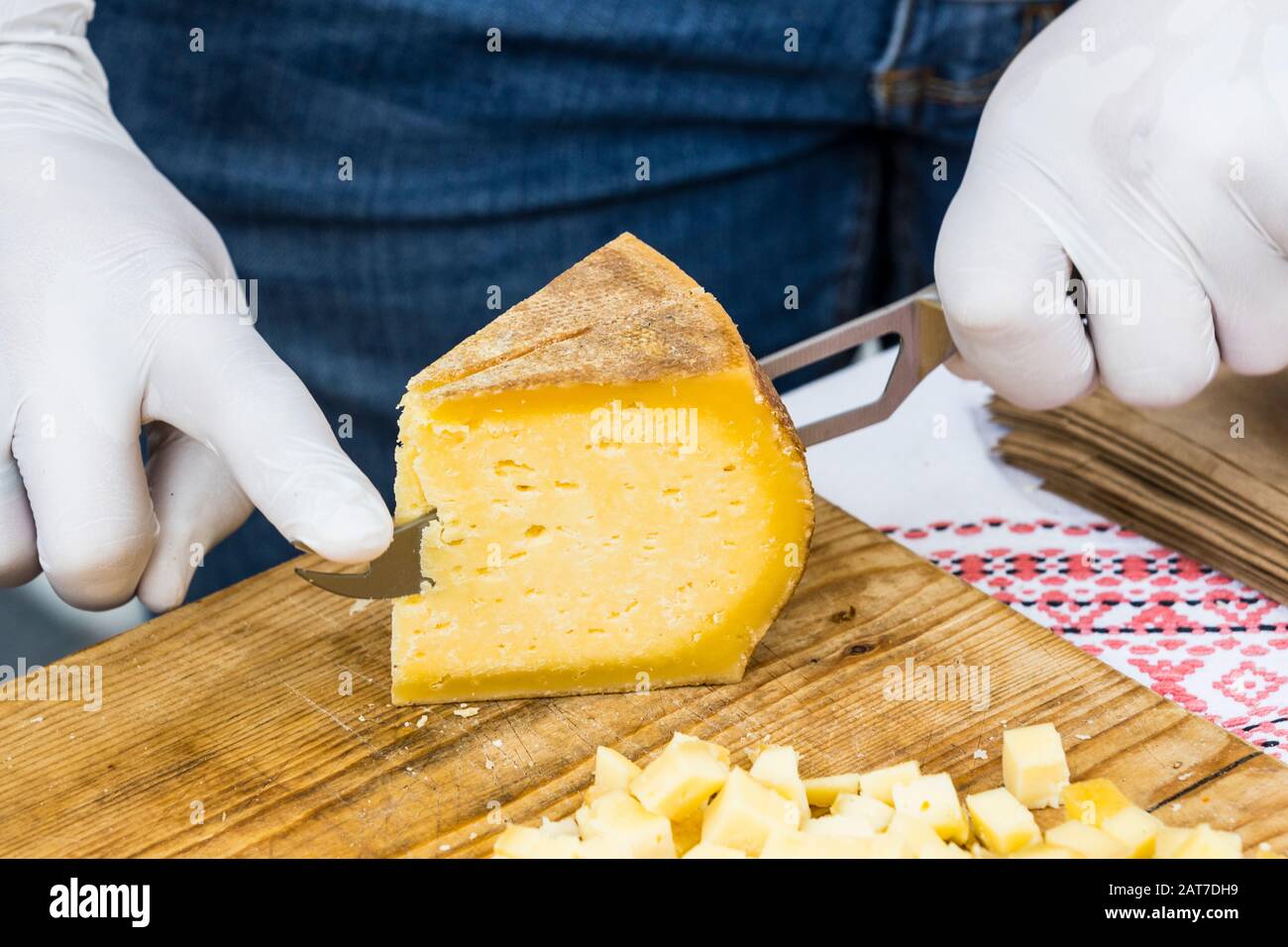 Chef's hands are cutting cheese with a knife for cutting cheese Stock ...