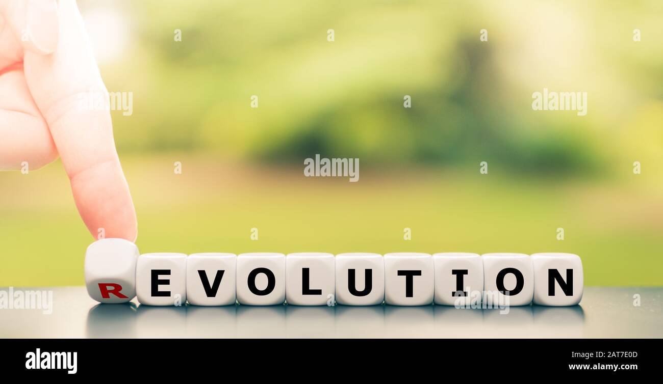 Evolution instead of revolution. Hand turns a dice and changes the word ...