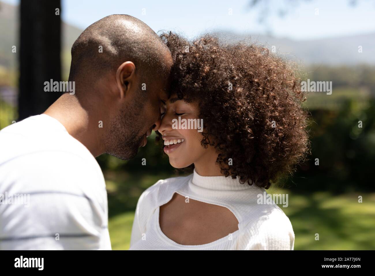 Happy couple holding each other Stock Photo - Alamy