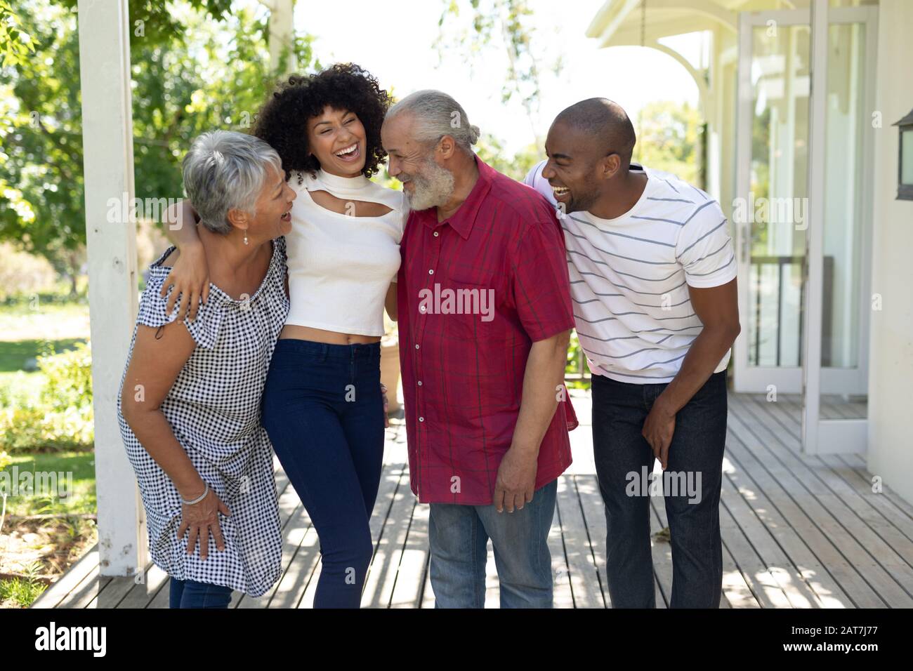 Happy family smiling to each other at home Stock Photo - Alamy