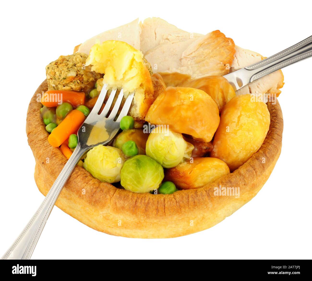 Roast chicken dinner in a large Yorkshire pudding isolated on a white ...