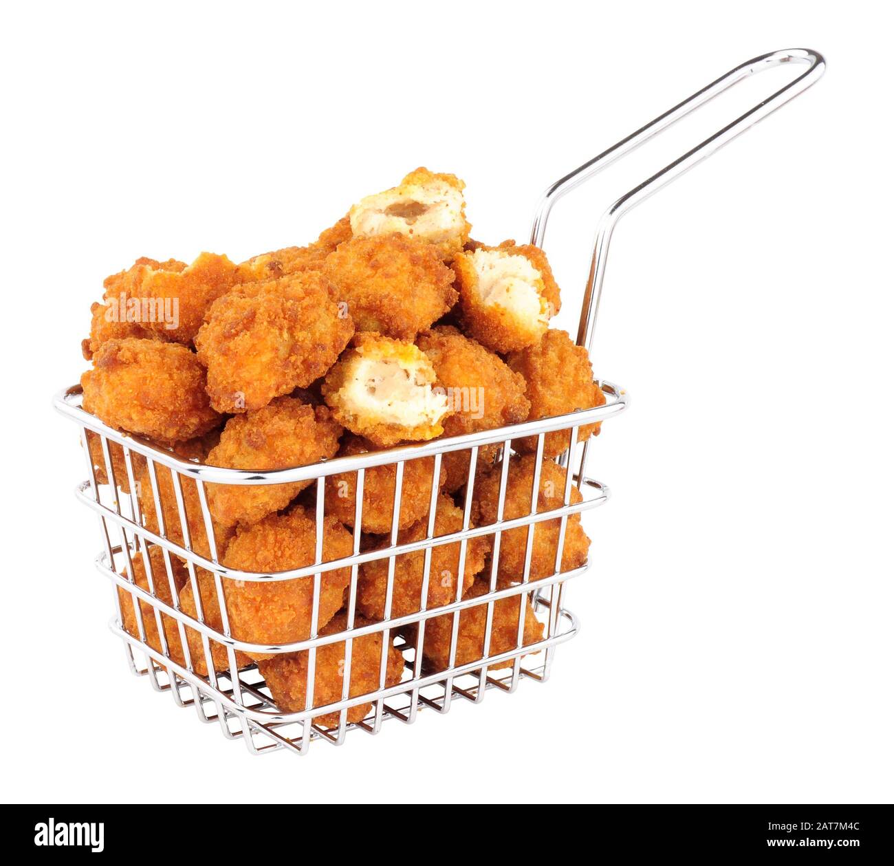 Fried breadcrumb covered chicken popcorn in a small wire frying basket ...