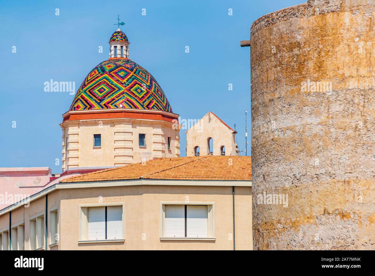 The colorful dome of a church in the old town of Alghero in Sardinia ...
