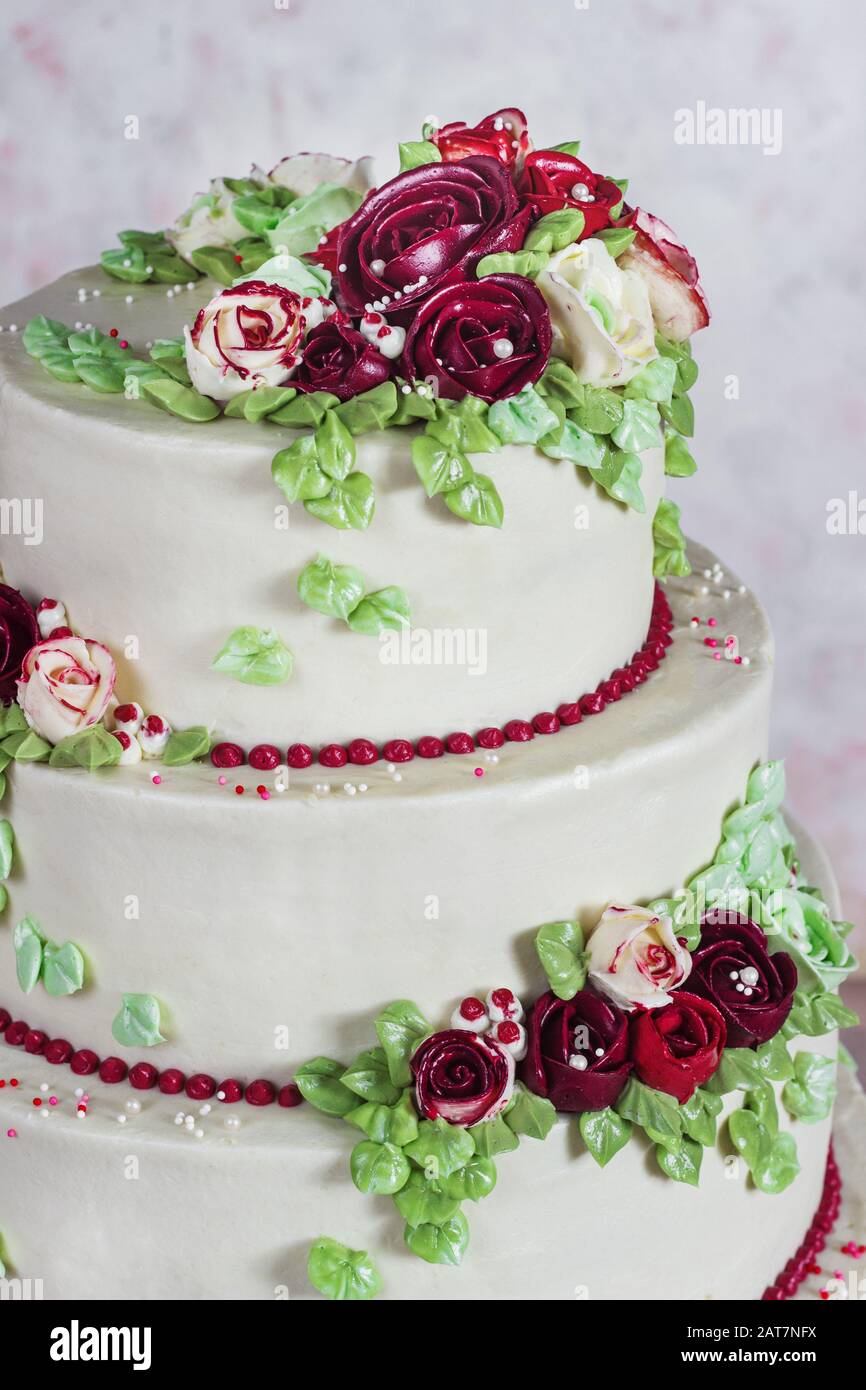 Festive four-level white elegant cake with cream flowers, wedding cake ...