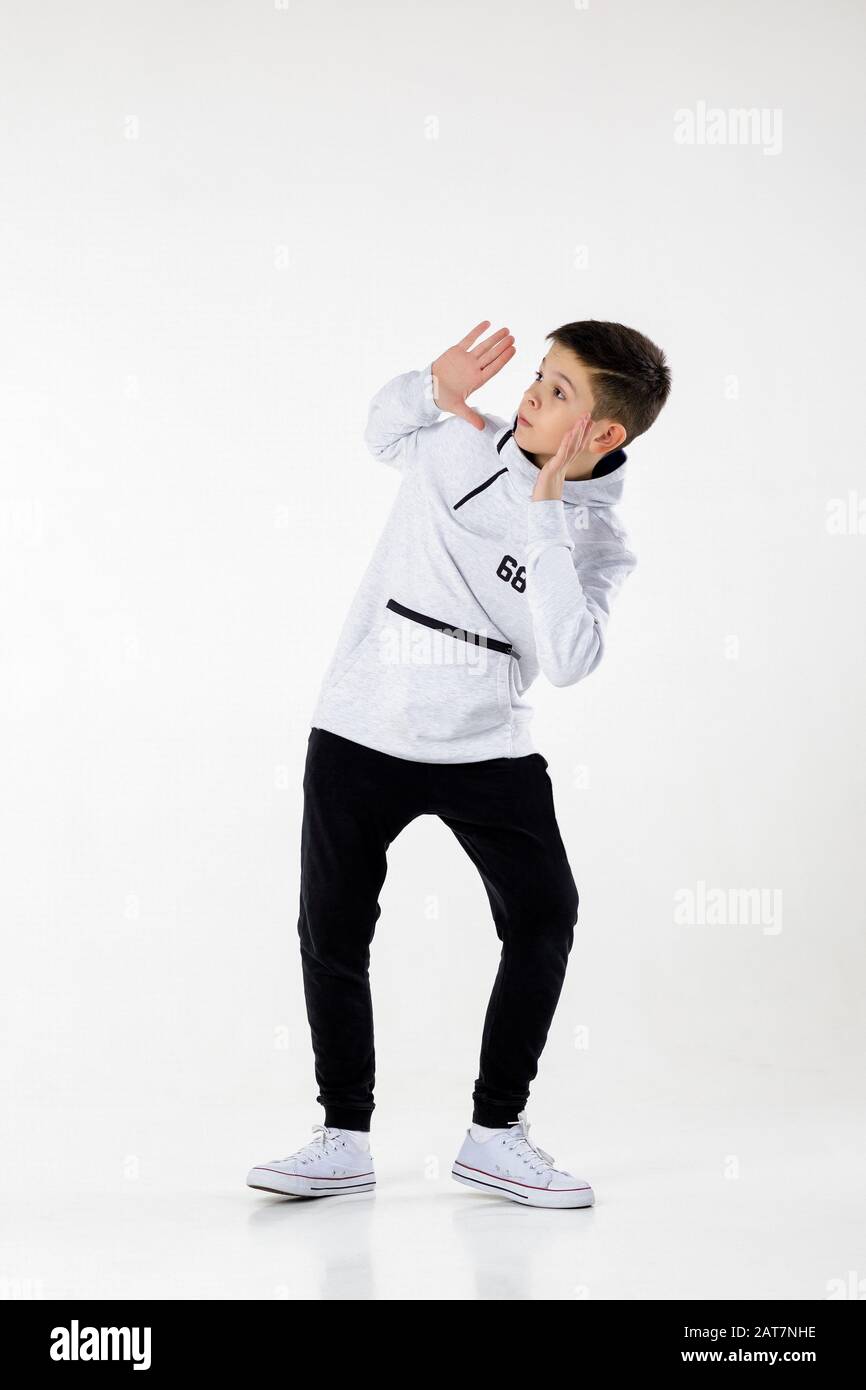 Little hip-hop boy dancing on white studio background. modern style ...