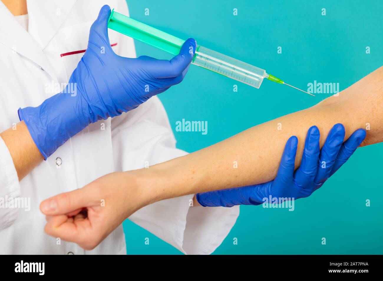 Female doctor or nurse with syringe giving injection to patient ...