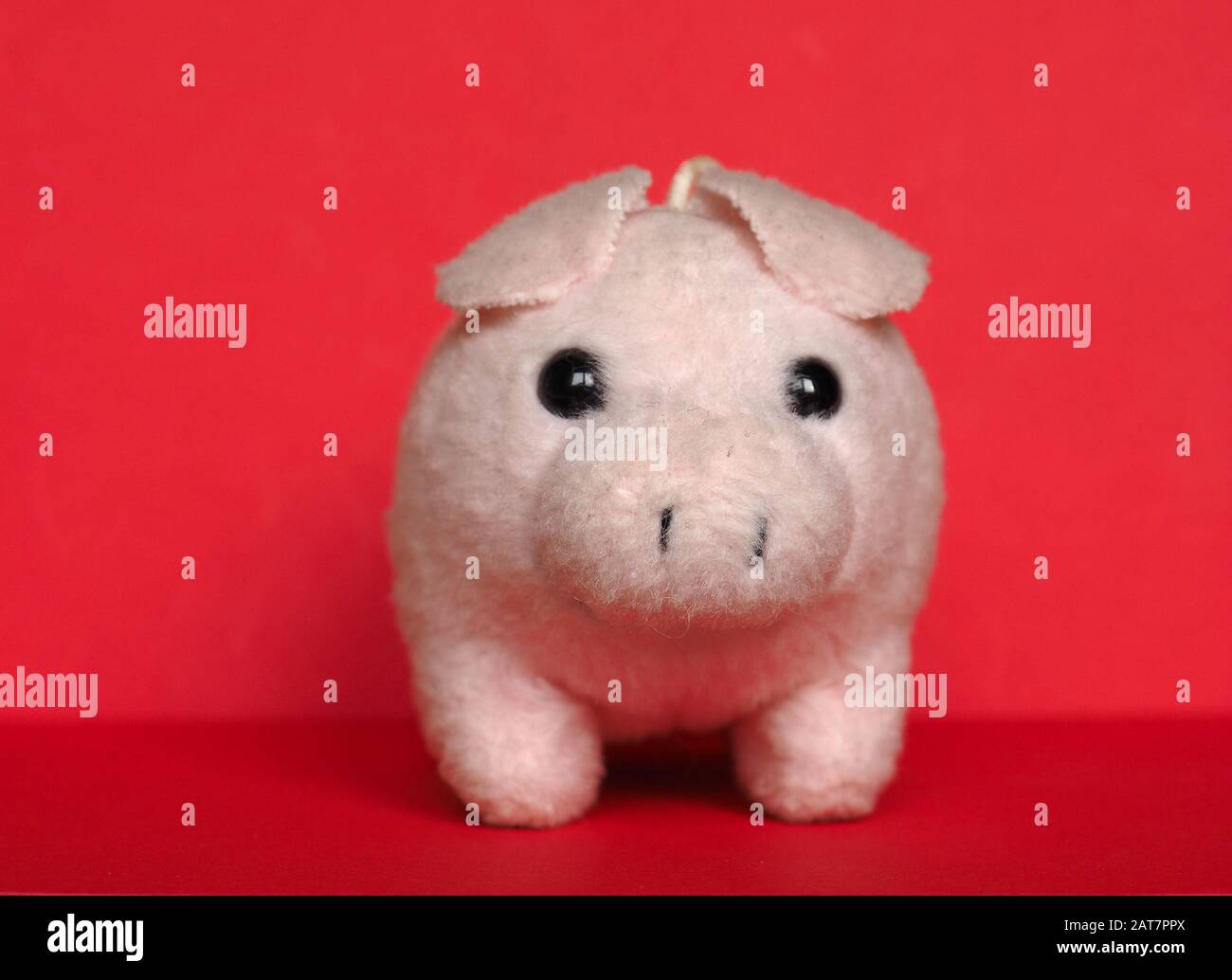 pink plush pig stuffed toy animal over red background Stock Photo - Alamy
