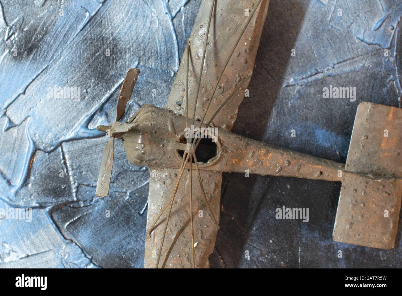 Metal plane on souvenir scale on gray background Stock Photo - Alamy