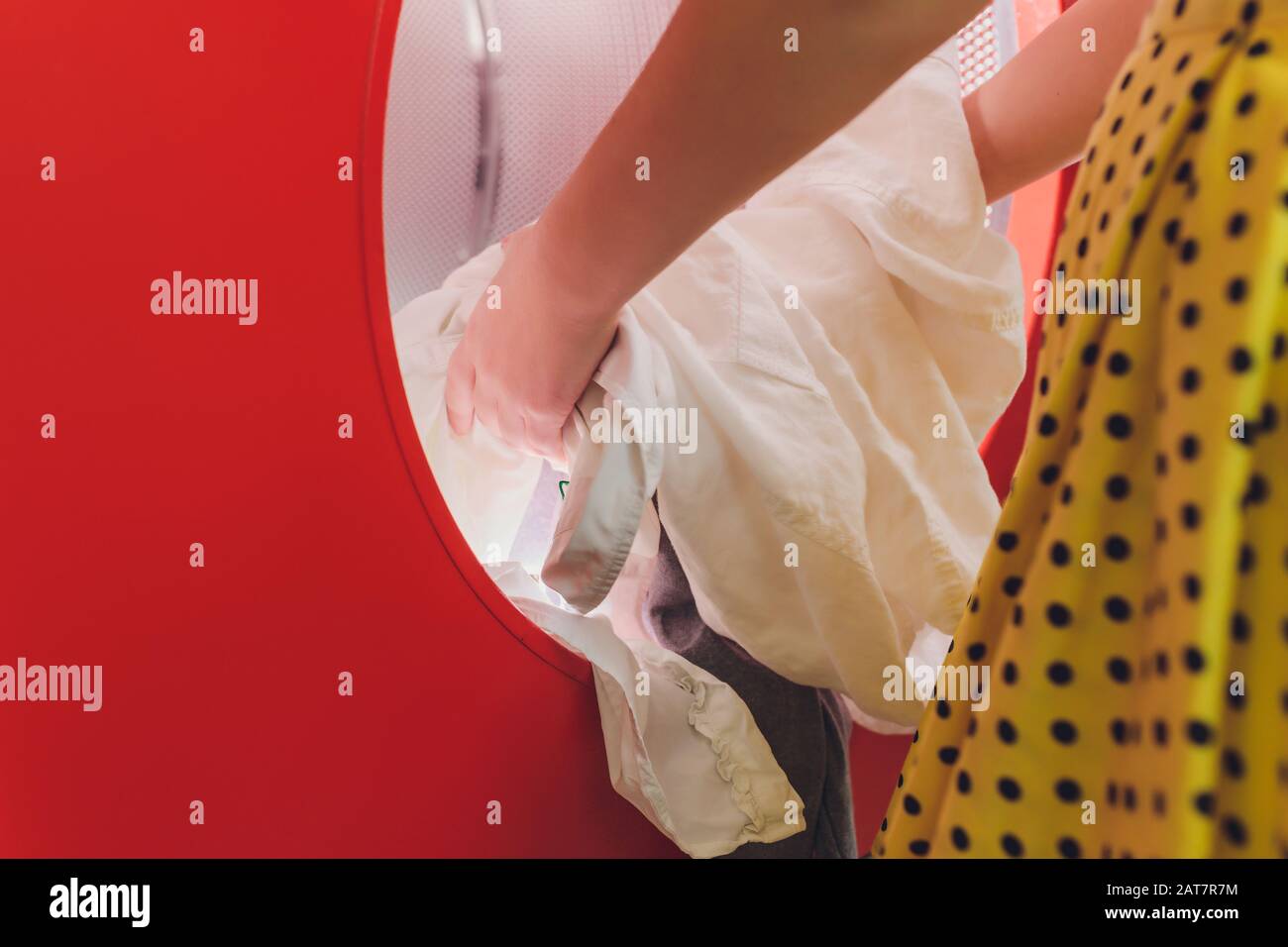 Hands to load the Laundry in the washing machine at the dry cleaners ...