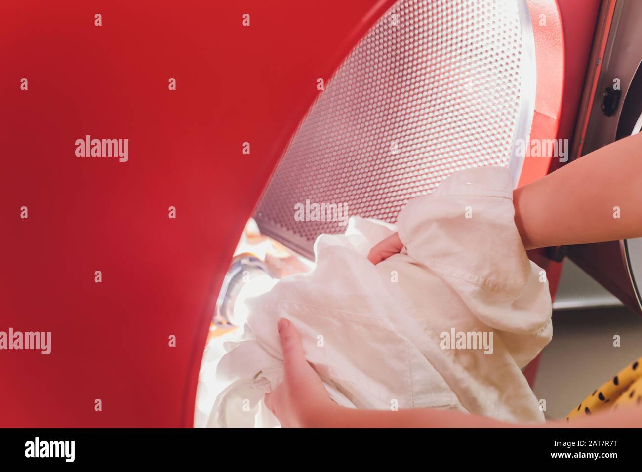 Hands to load the Laundry in the washing machine at the dry cleaners ...