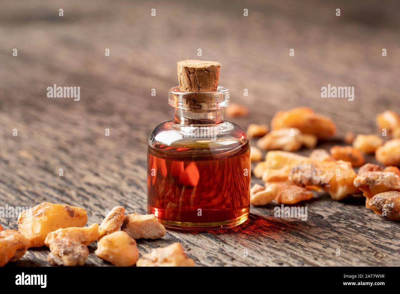 A transparent bottle of styrax benzoin essential oil on a table Stock ...
