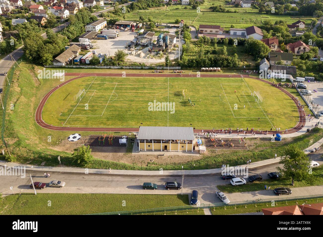 Aerial view of a football field on a stadium covered with green grass ...