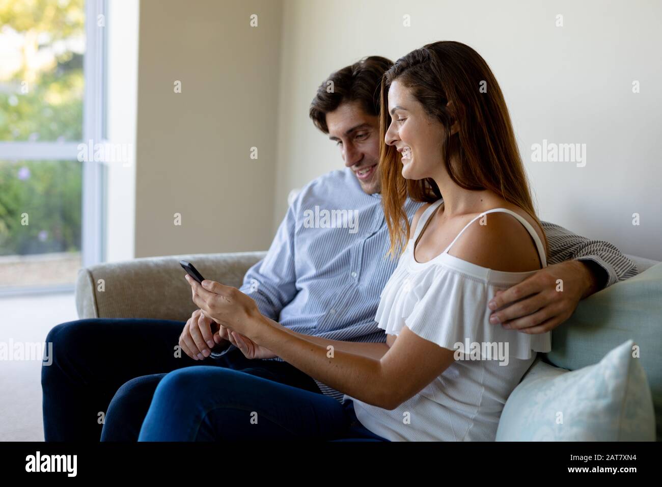 Couple interacting using mobile phone hi-res stock photography and ...