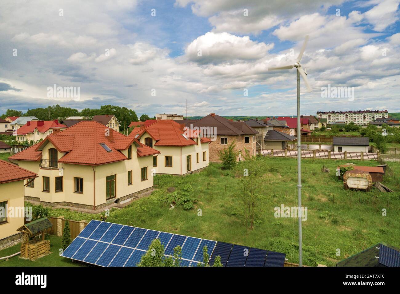 Aerial view of a residential private house with solar panels on roof ...