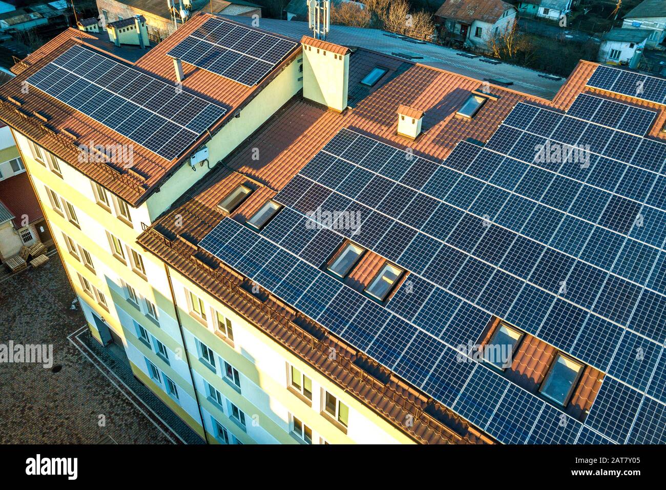 Aerial view of many photo voltaic solar panels mounted of industrial ...