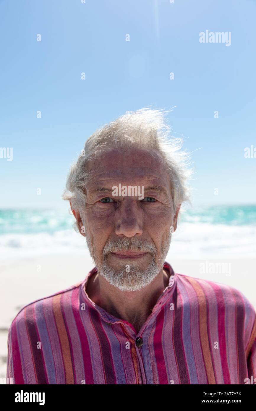 Old man looking at the camera at the beach Stock Photo - Alamy