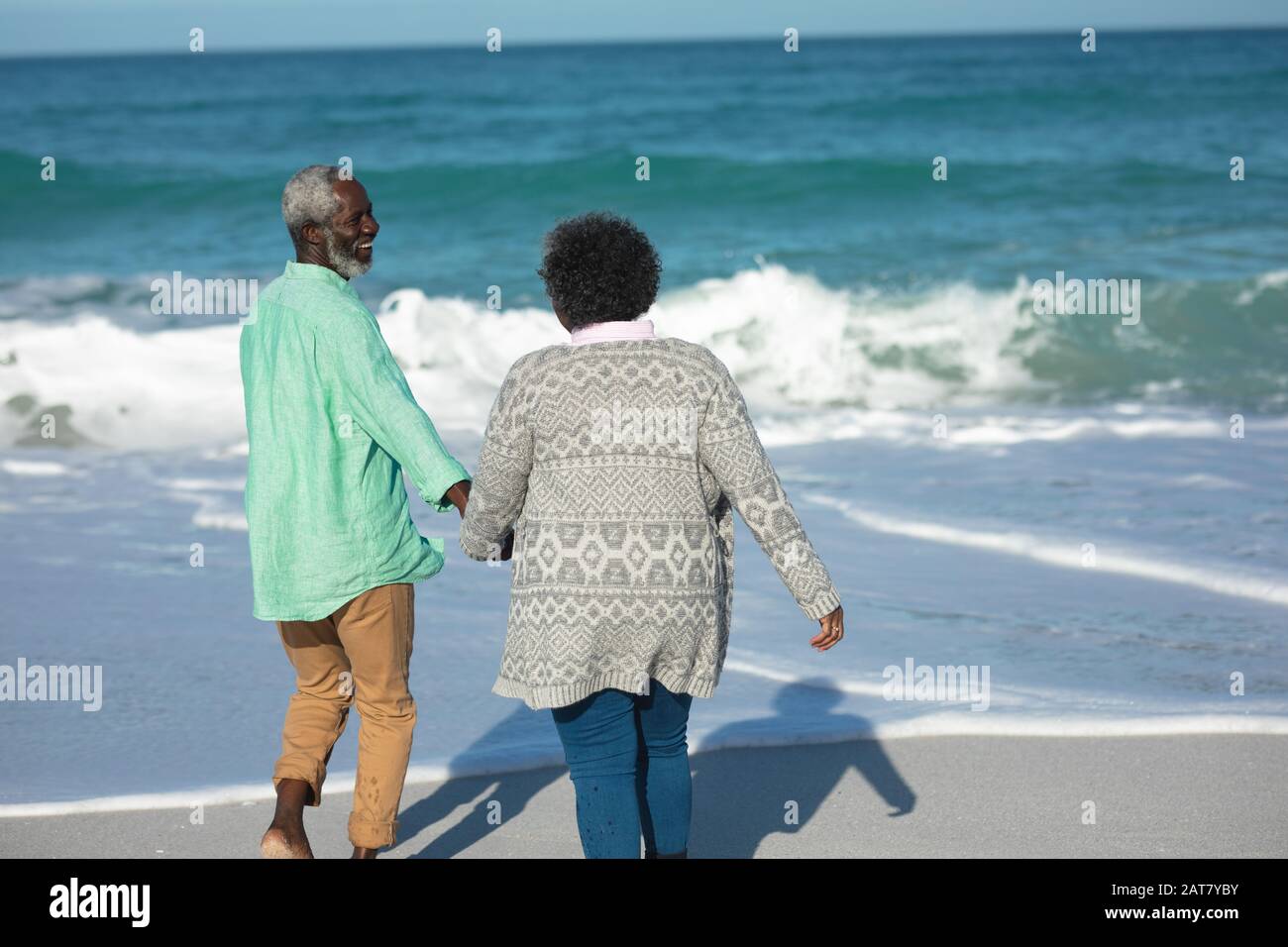 Old couple walking at the beach Stock Photo - Alamy