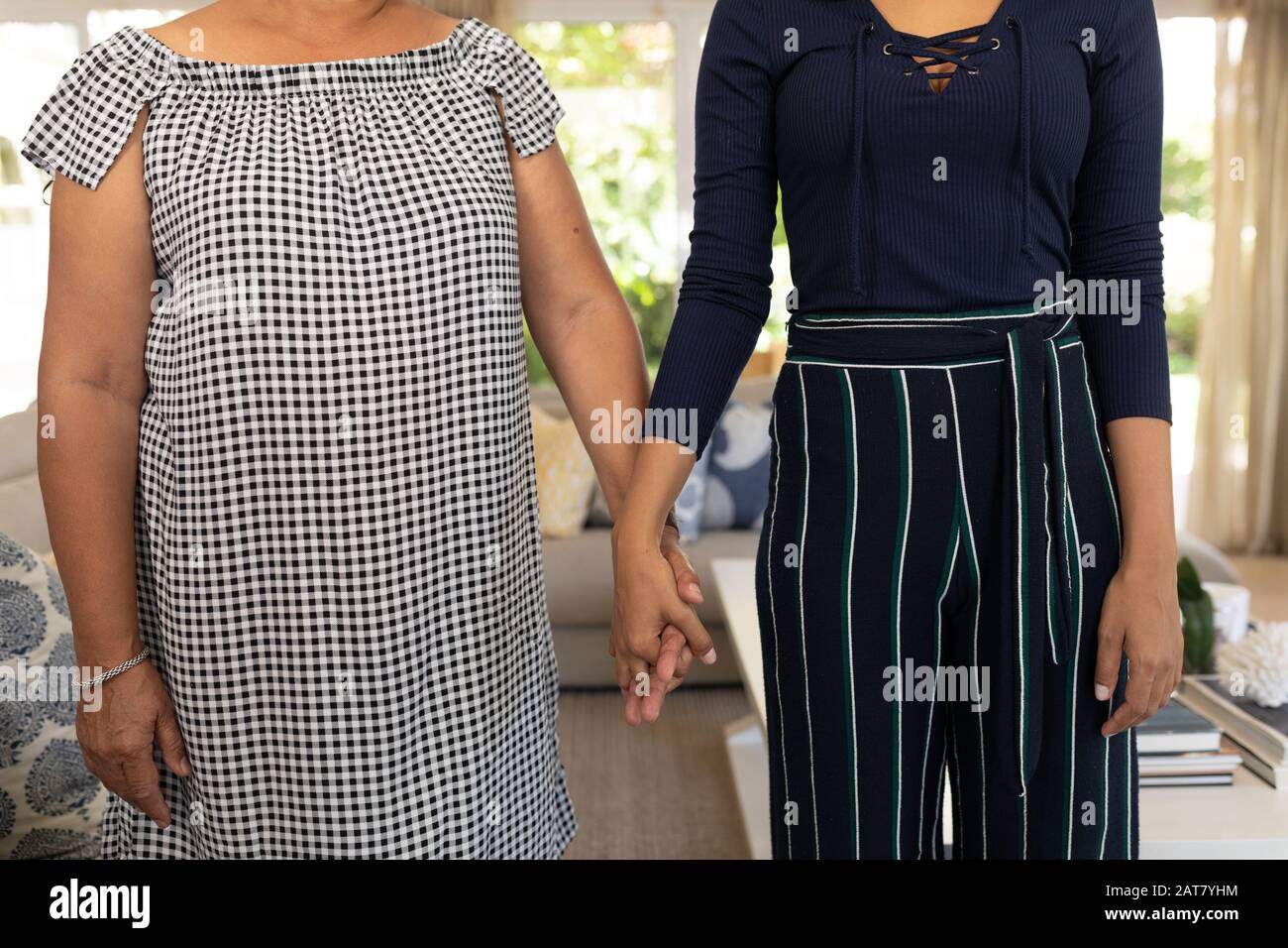 Two women holding hands hi-res stock photography and images - Alamy