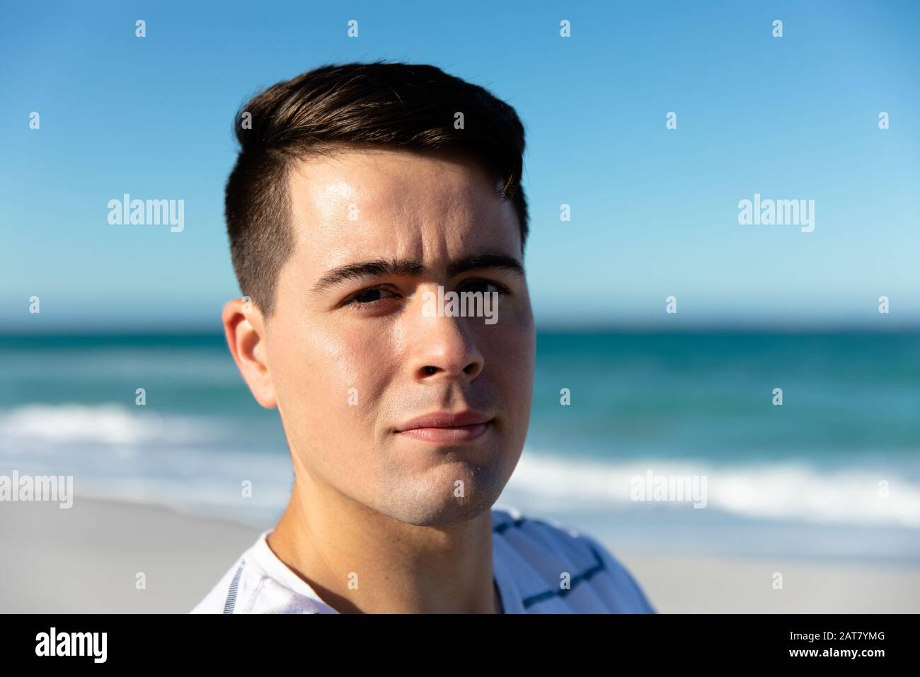 Young man at the beach hi-res stock photography and images - Alamy