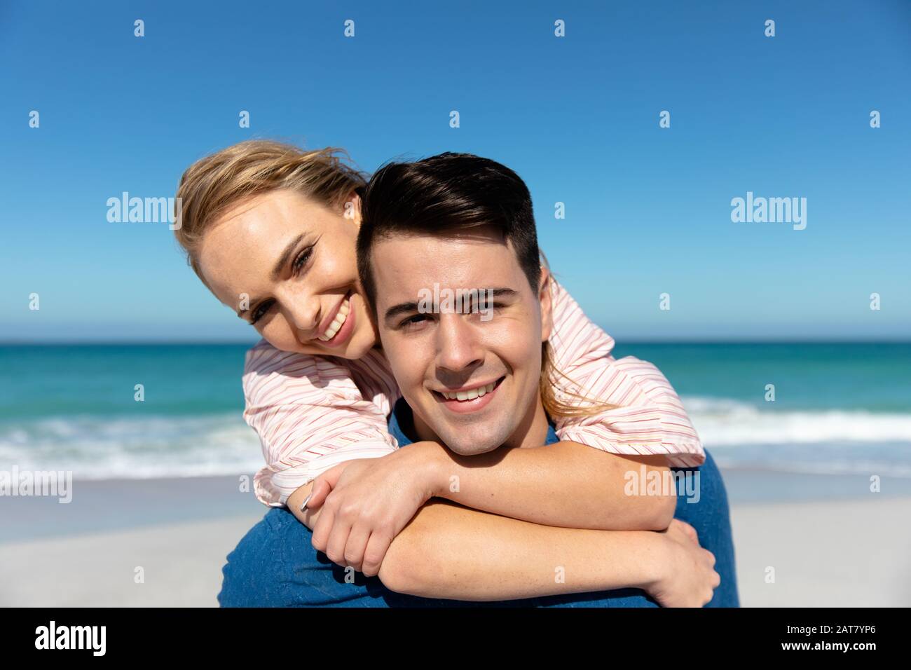 Young couple hugging at the beach Stock Photo - Alamy