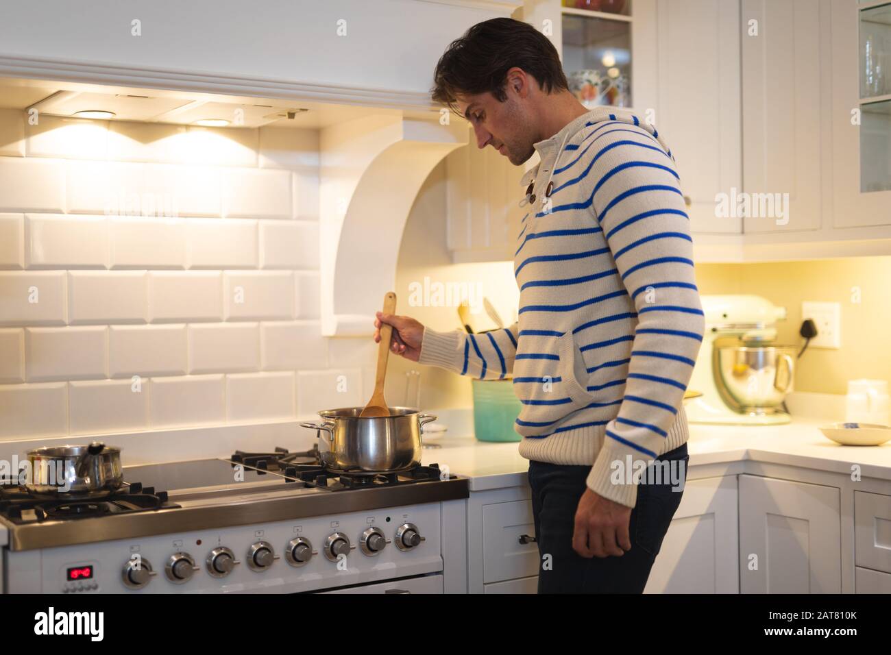 Young man cooking hi-res stock photography and images - Alamy