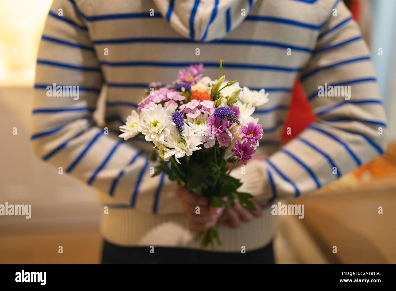 Man holding flowers behind back hi-res stock photography and images - Alamy