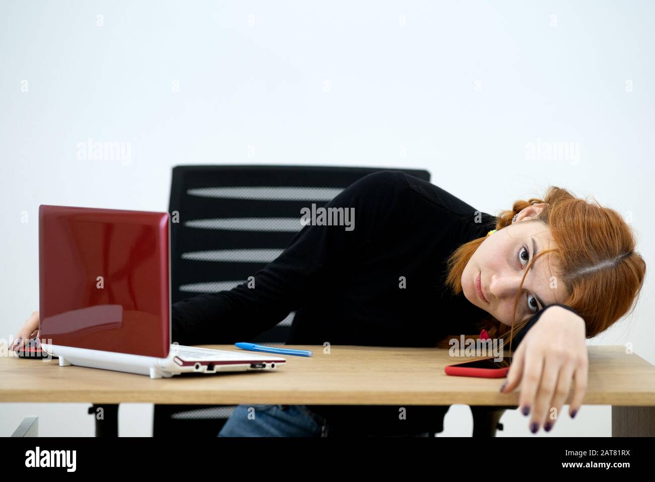 Tired office worker woman having a nap behind working desk Stock Photo ...