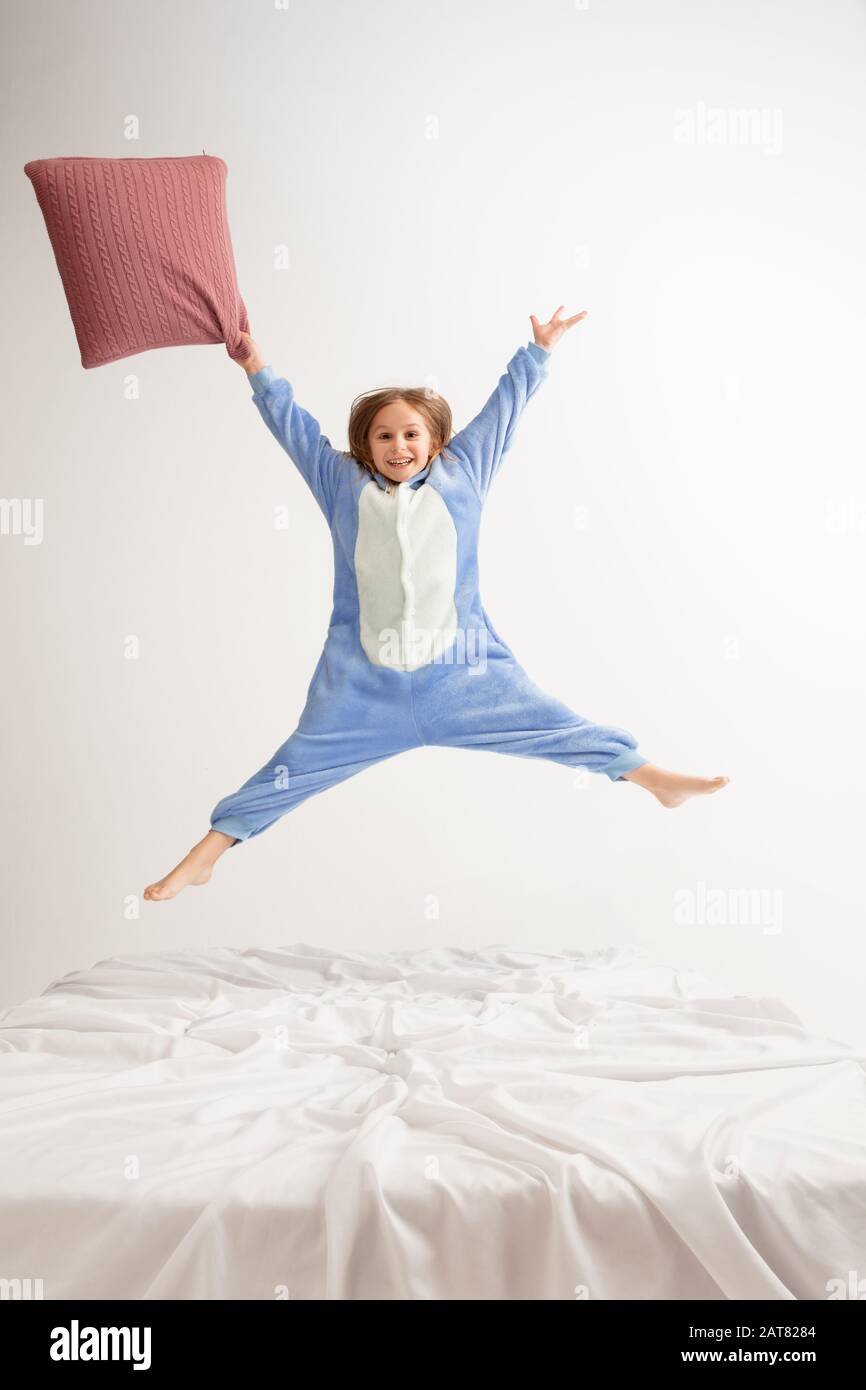 Little girl in soft warm pajama colored bright playing at home. Cute ...