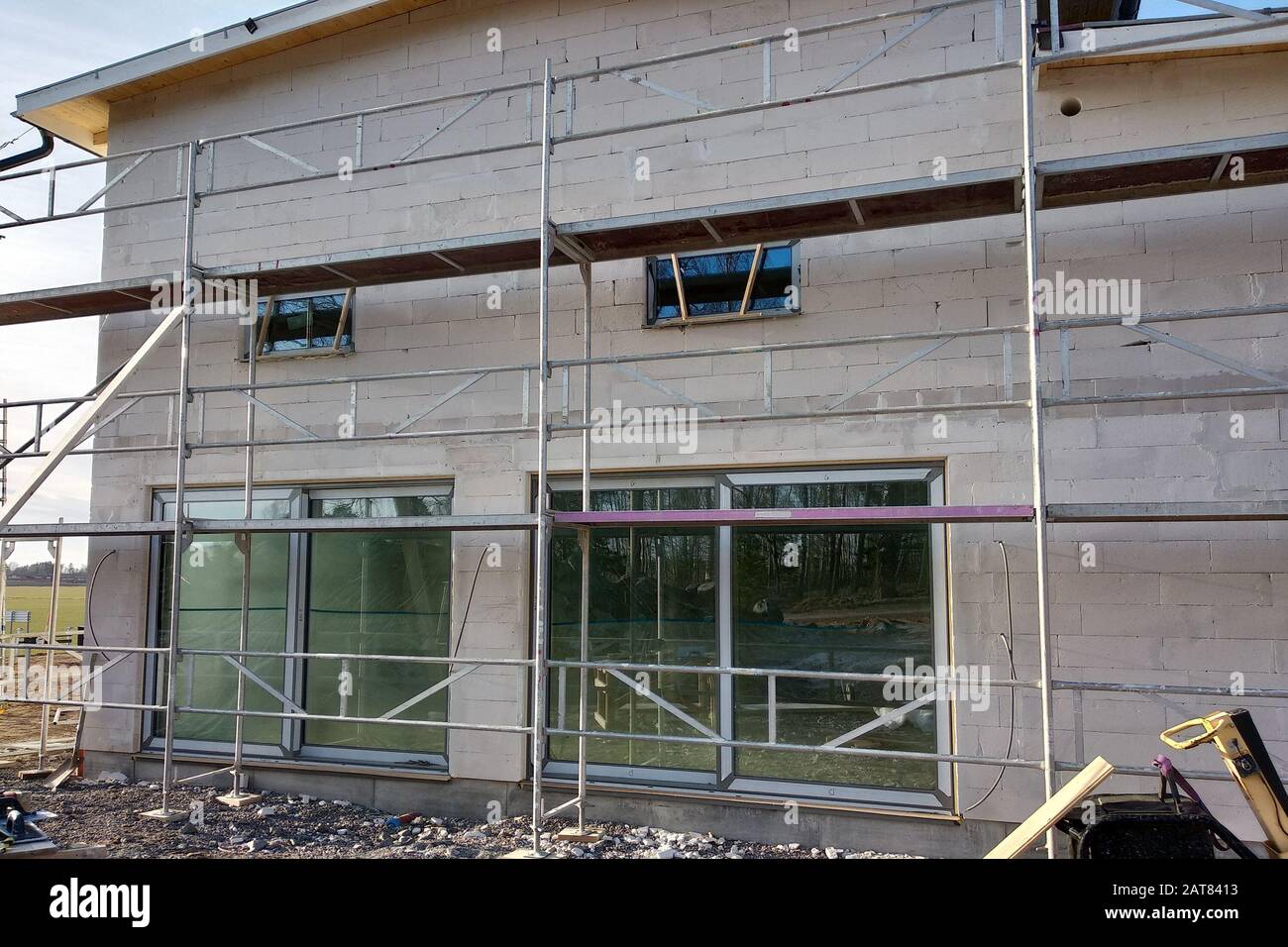 Facade of building made from white blocks with big windows under ...