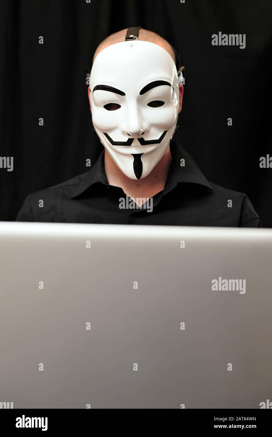 member of the Anonymous hacker group, in front of the laptop Stock ...