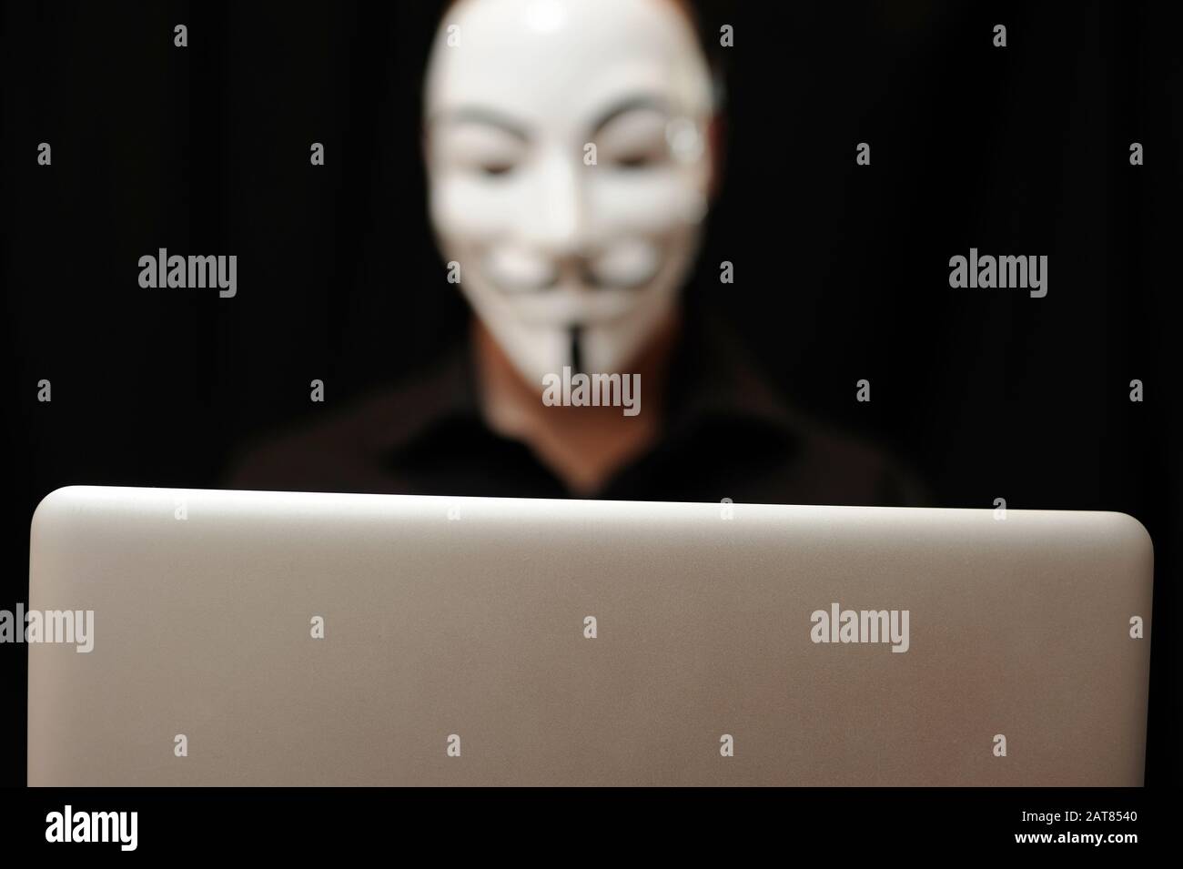 member of the Anonymous hacker group, in front of the laptop Stock ...
