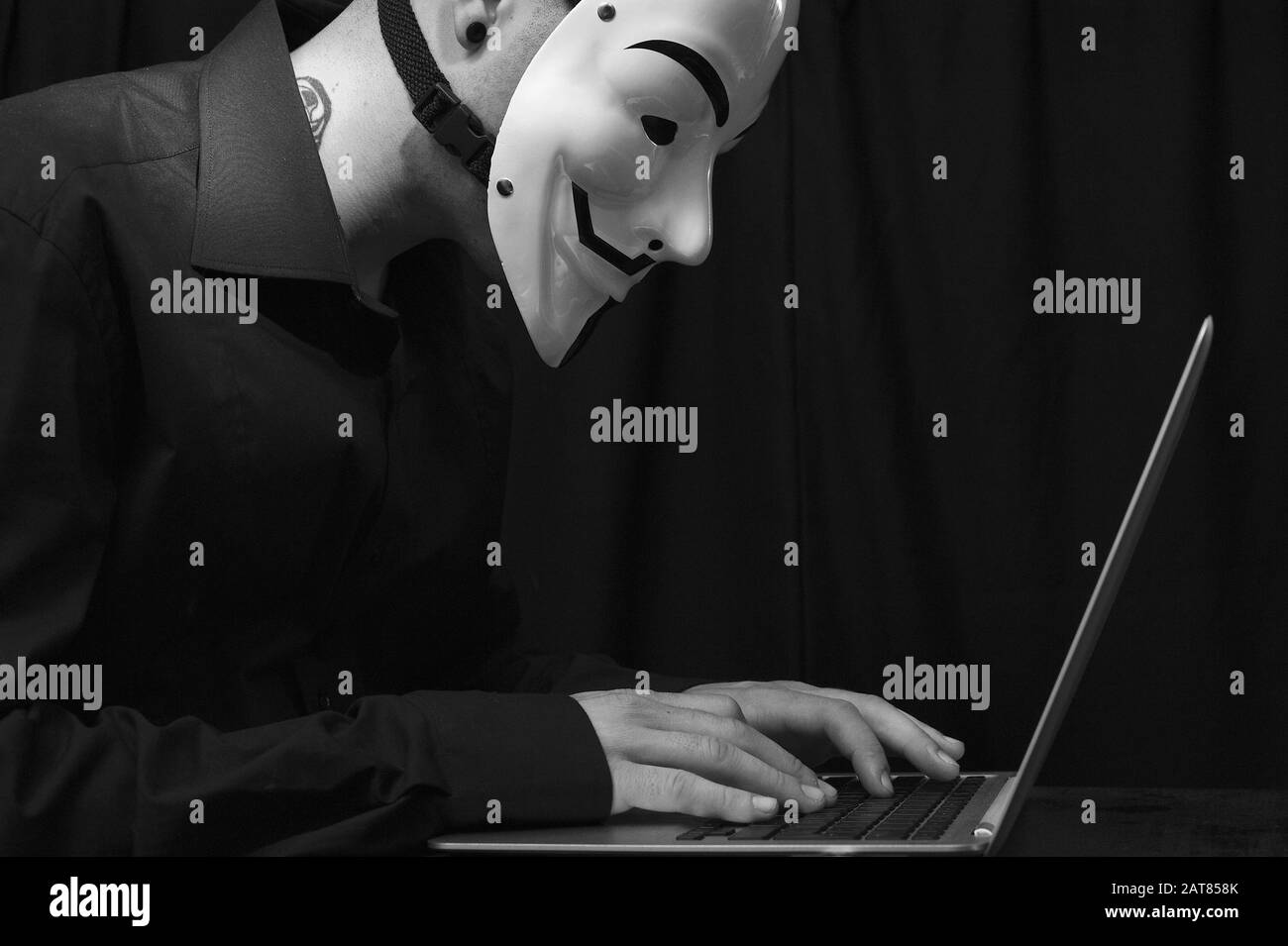 member of the Anonymous hacker group in front of the laptop Stock Photo ...