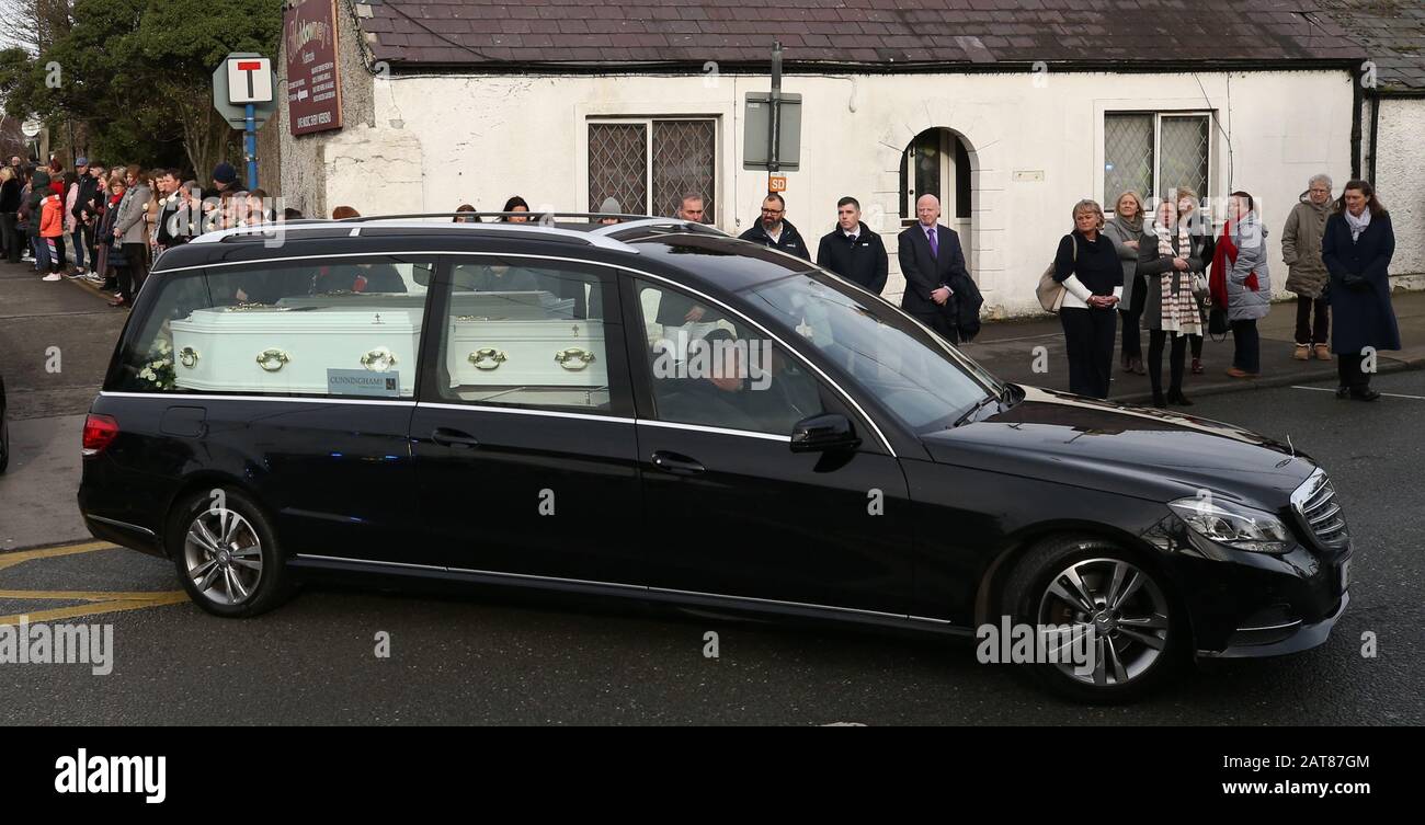 A hearse carrying the coffins of siblings, Conor, nine, Darragh, seven ...