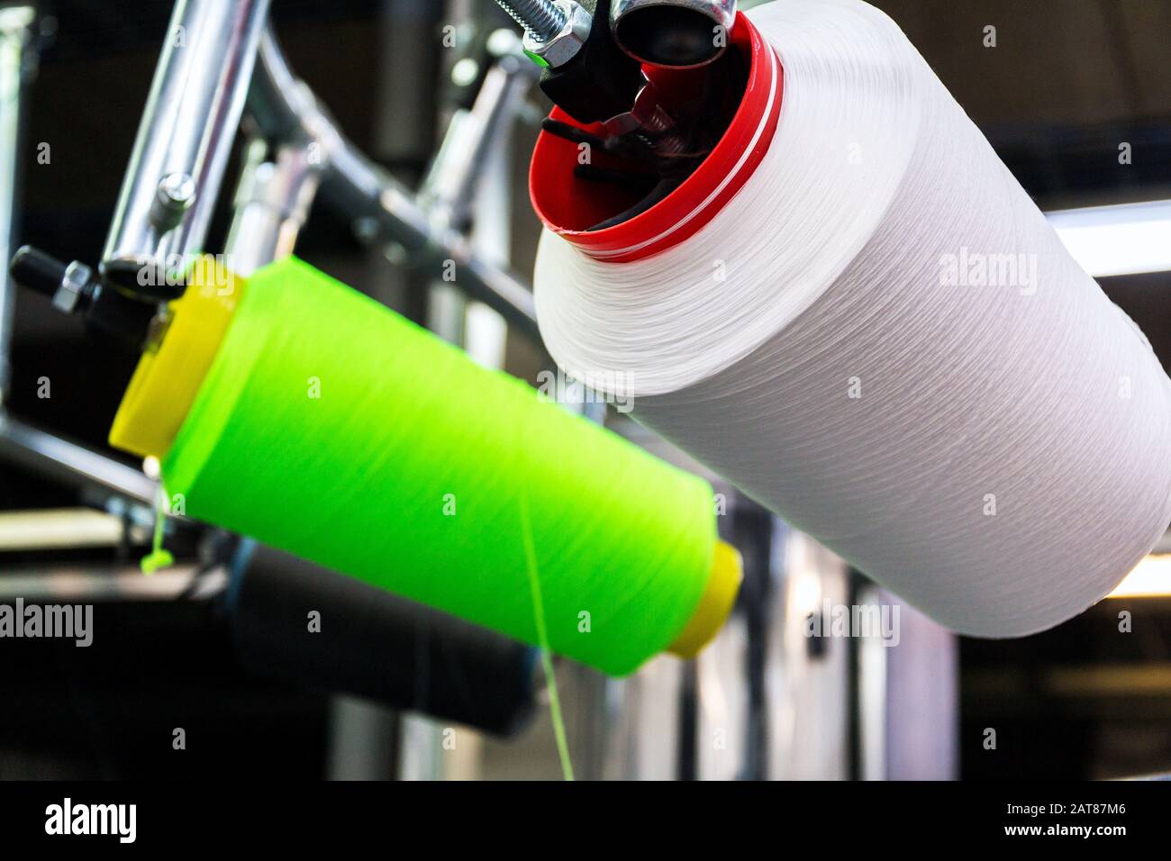 Colorful reel thread set up at modern and automatic sewing or ...