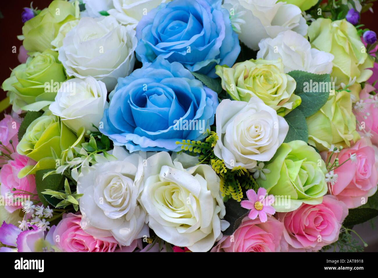 Colorful plastic roses and other flowers for decoration and furniture ...