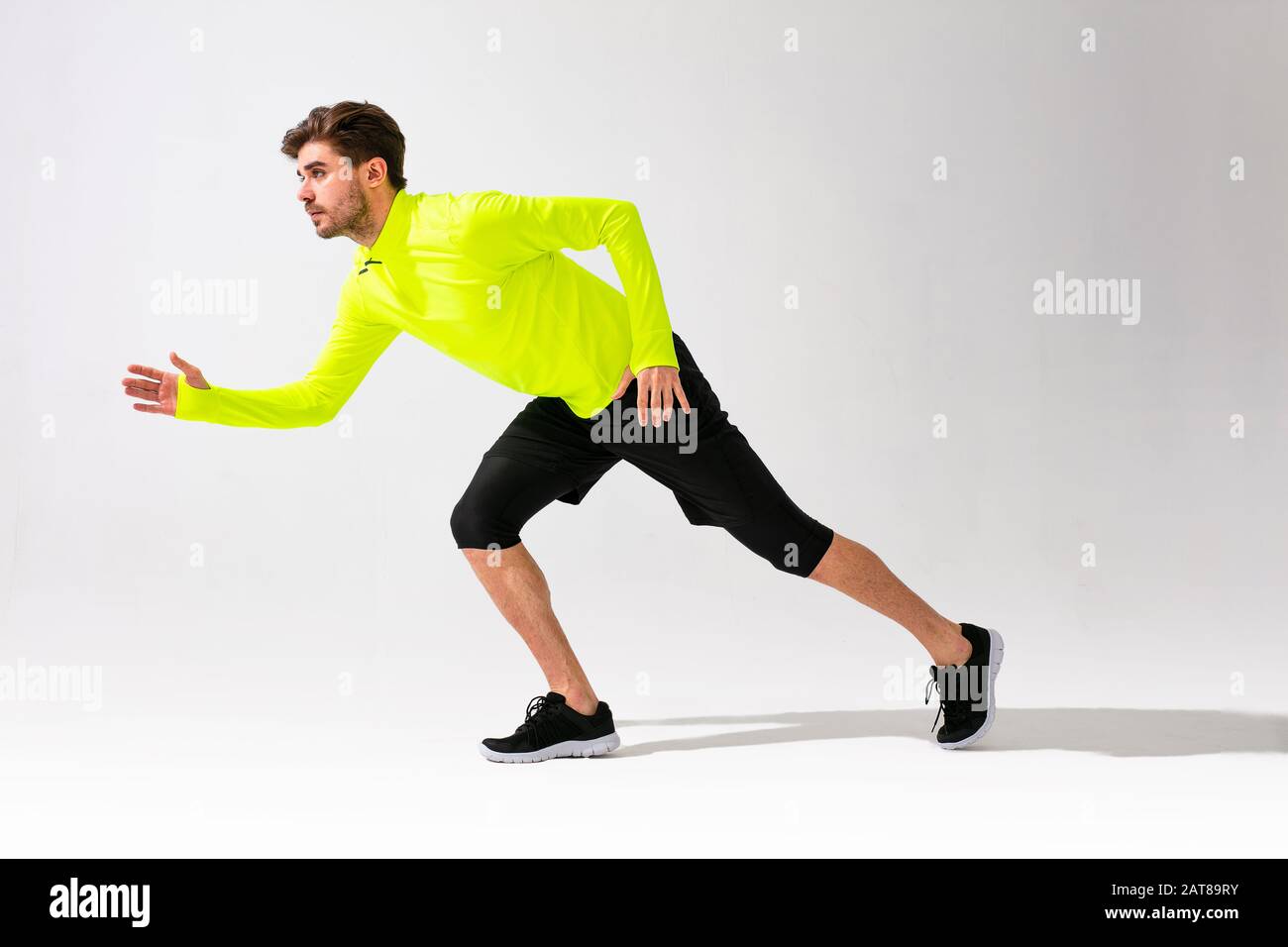 young normal person doing exercise and running, studio shoot isolated ...