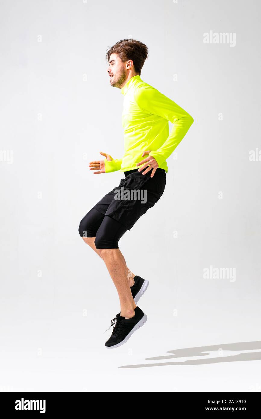 young normal person doing exercise and running, studio shoot isolated ...
