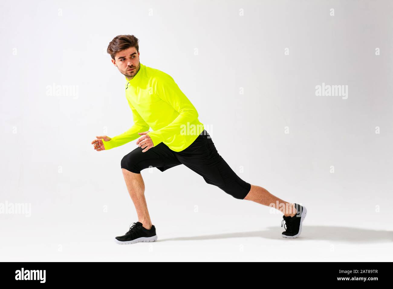 young normal person doing exercise and running, studio shoot isolated ...
