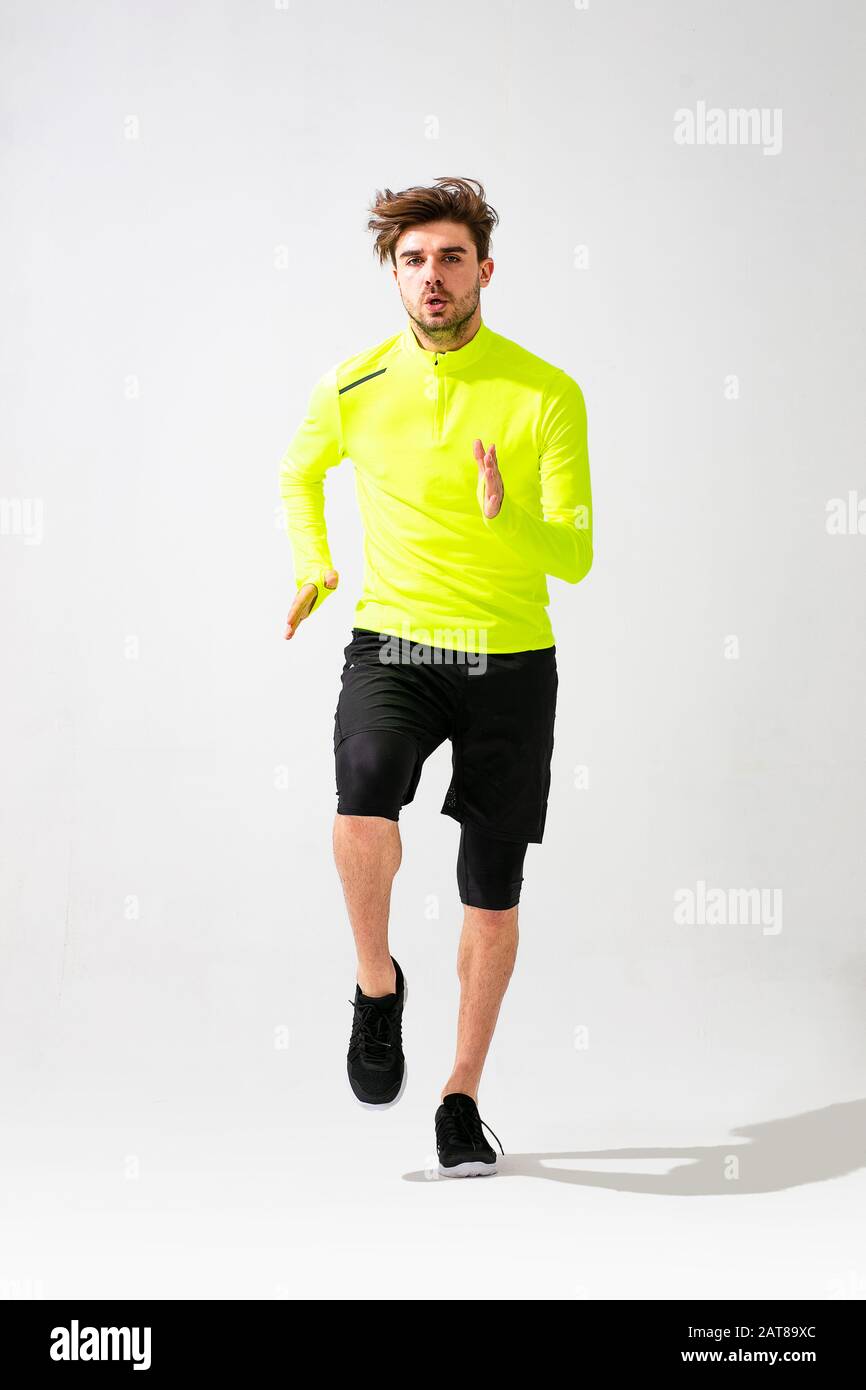 young normal person doing exercise and running, studio shoot isolated ...