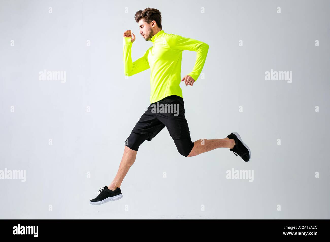 young normal person doing exercise and running, studio shoot isolated ...