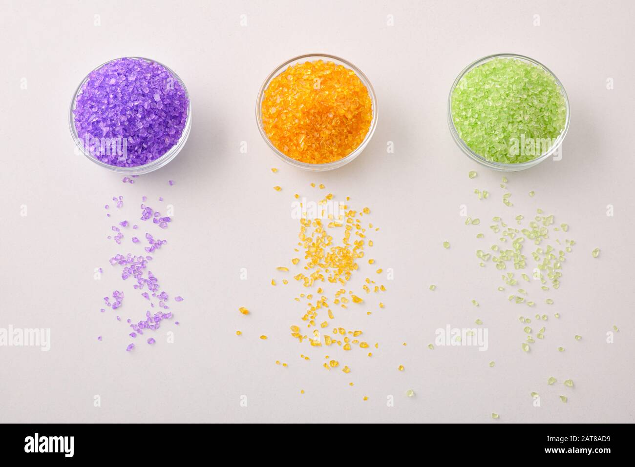 Bath salts in containers on white table top. Products for body wellness ...
