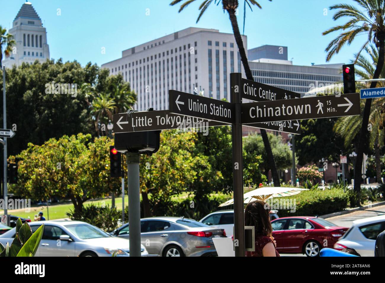 Black sign which shows four directions with beautiful white buildings ...