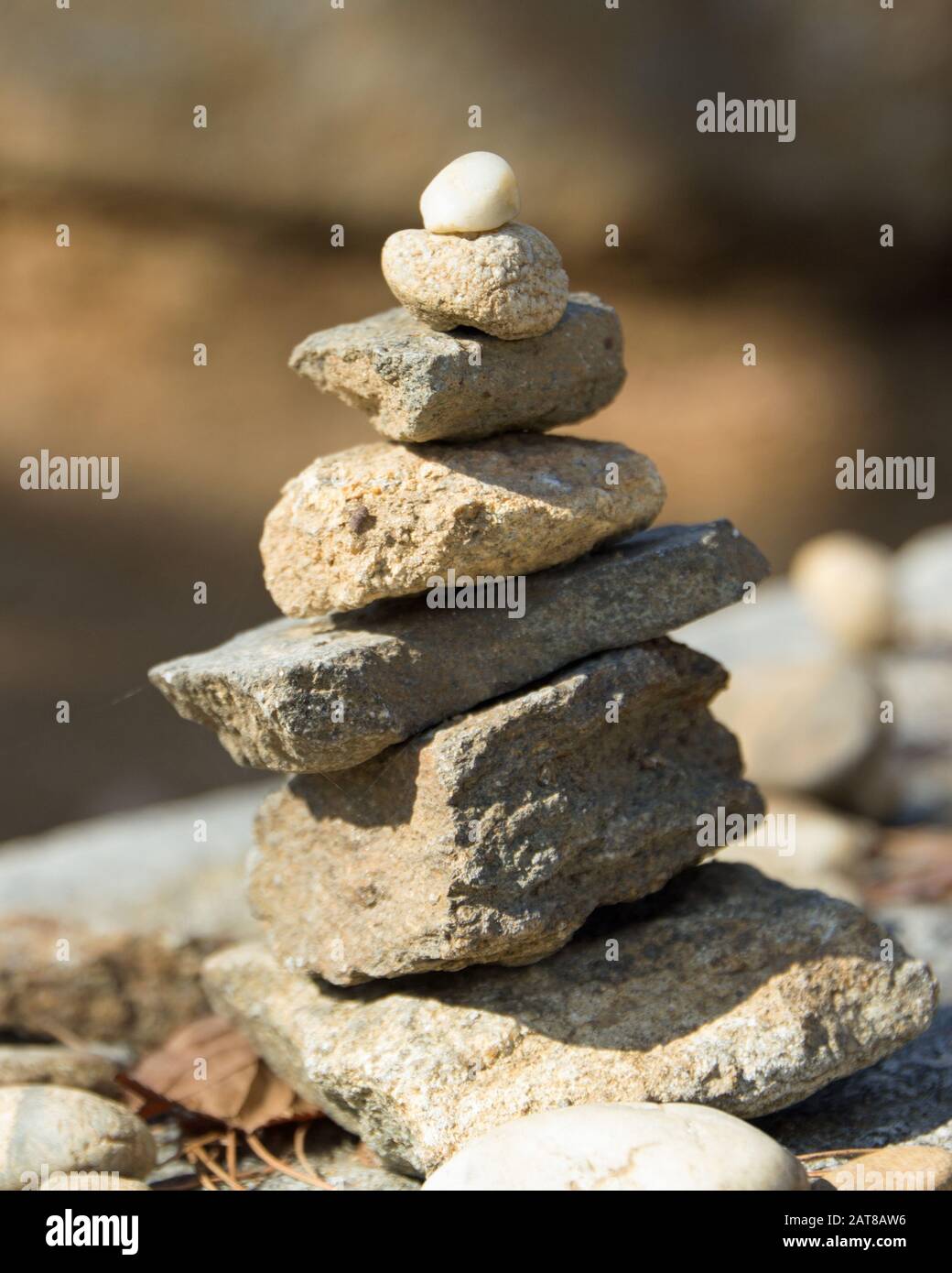 Vertical picture of stones on top of each other under the sunlight with ...